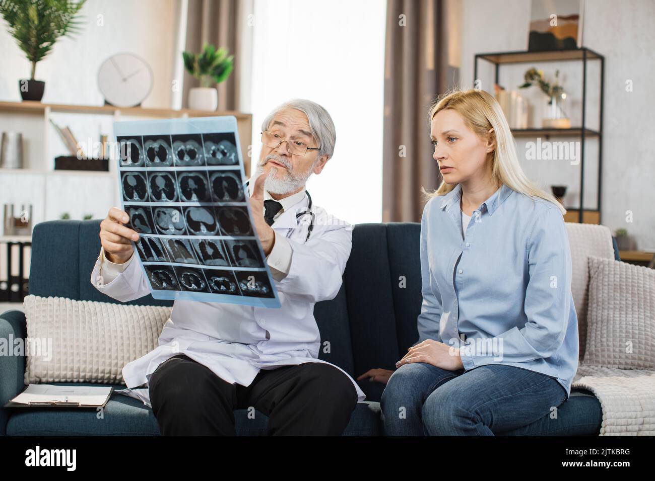 Senior attractive high-skilled caring male doctor explaining results of ...