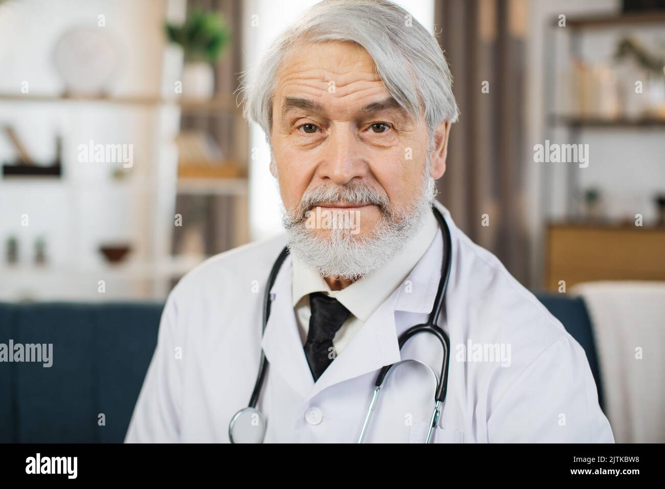 Senior grey hair caucasian male physician with a stethoscope on his ...