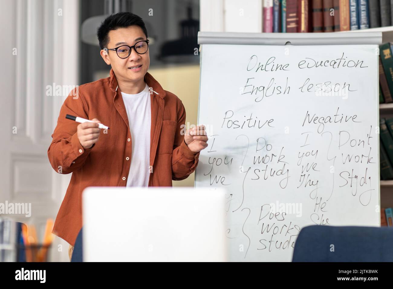 Korean Male Teacher Talking To Laptop Teaching Online In Classroom ...