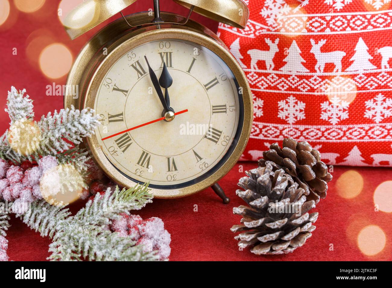New year red background with snow fir christmas tree, alarm clock and ...
