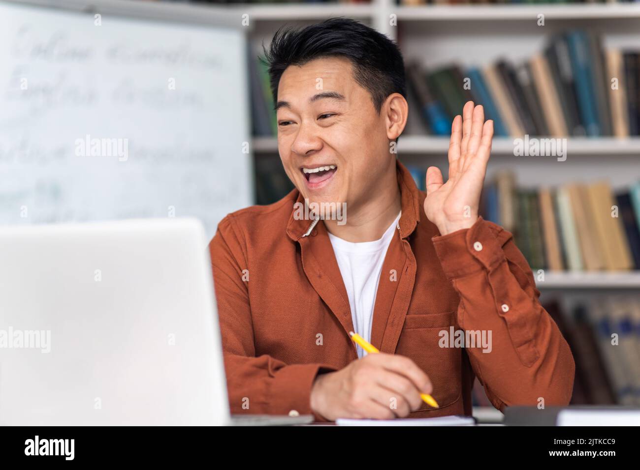 Joyful Korean Male Teacher Making Video Call Waving Hello Indoors Stock ...