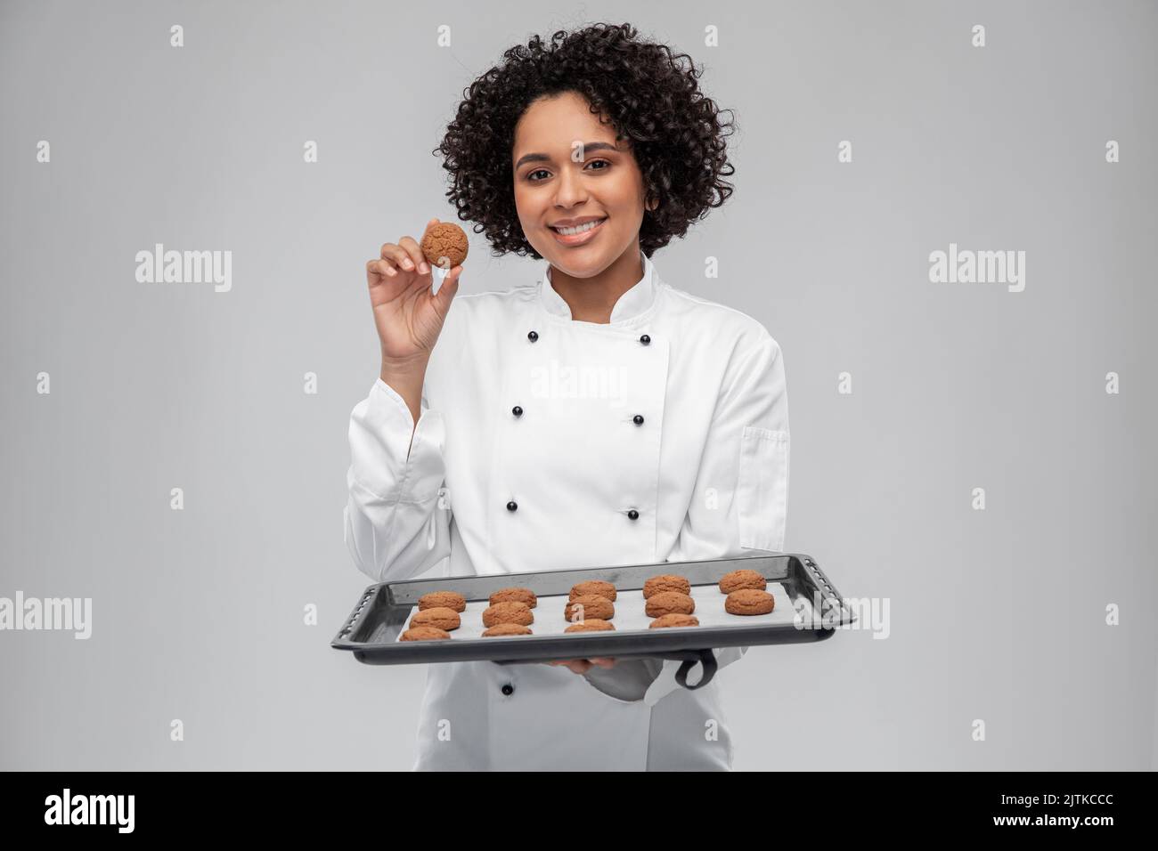 happy female chef with cookies on oven tray Stock Photo - Alamy