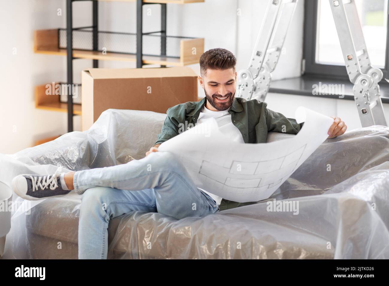happy man with blueprint moving to new home Stock Photo - Alamy