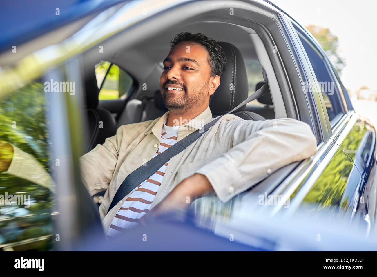 smiling indian man or driver driving car Stock Photo - Alamy