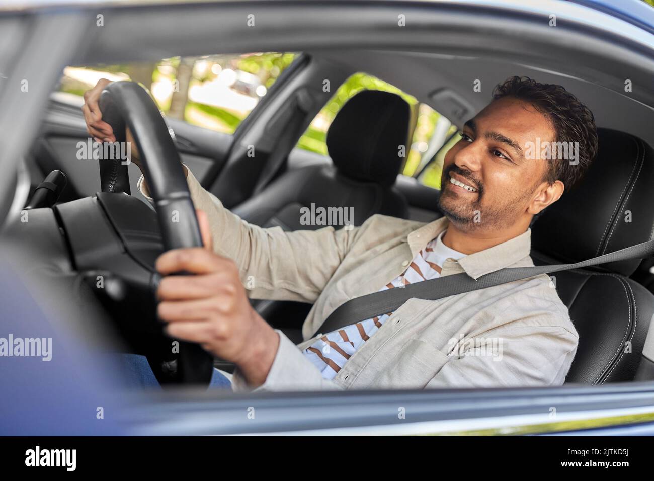 smiling indian man or driver driving car Stock Photo - Alamy