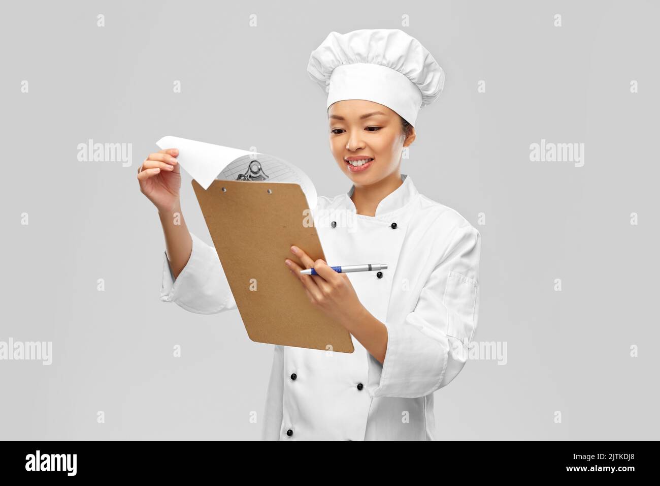 smiling female chef with clipboard and pen Stock Photo - Alamy