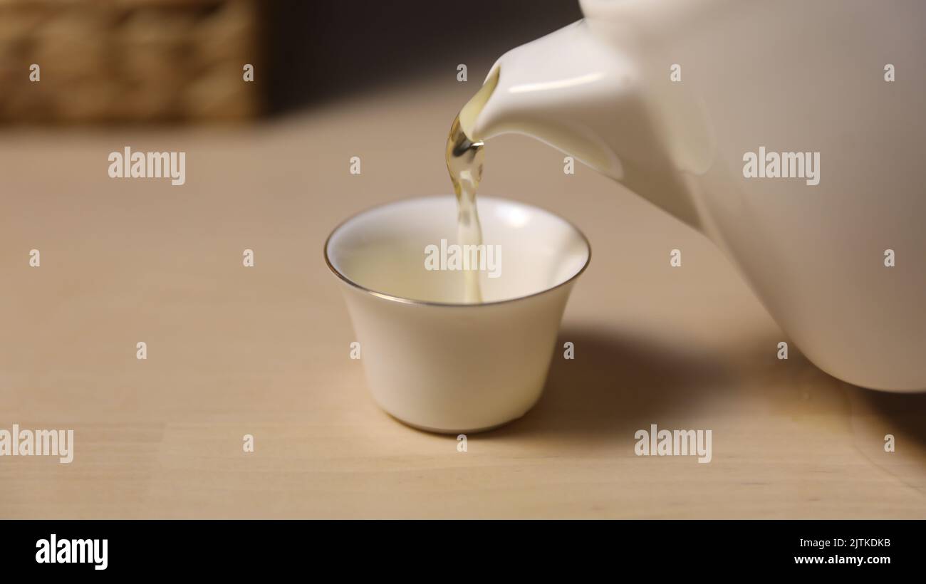 Pouring tea into an empty cup Stock Photo - Alamy