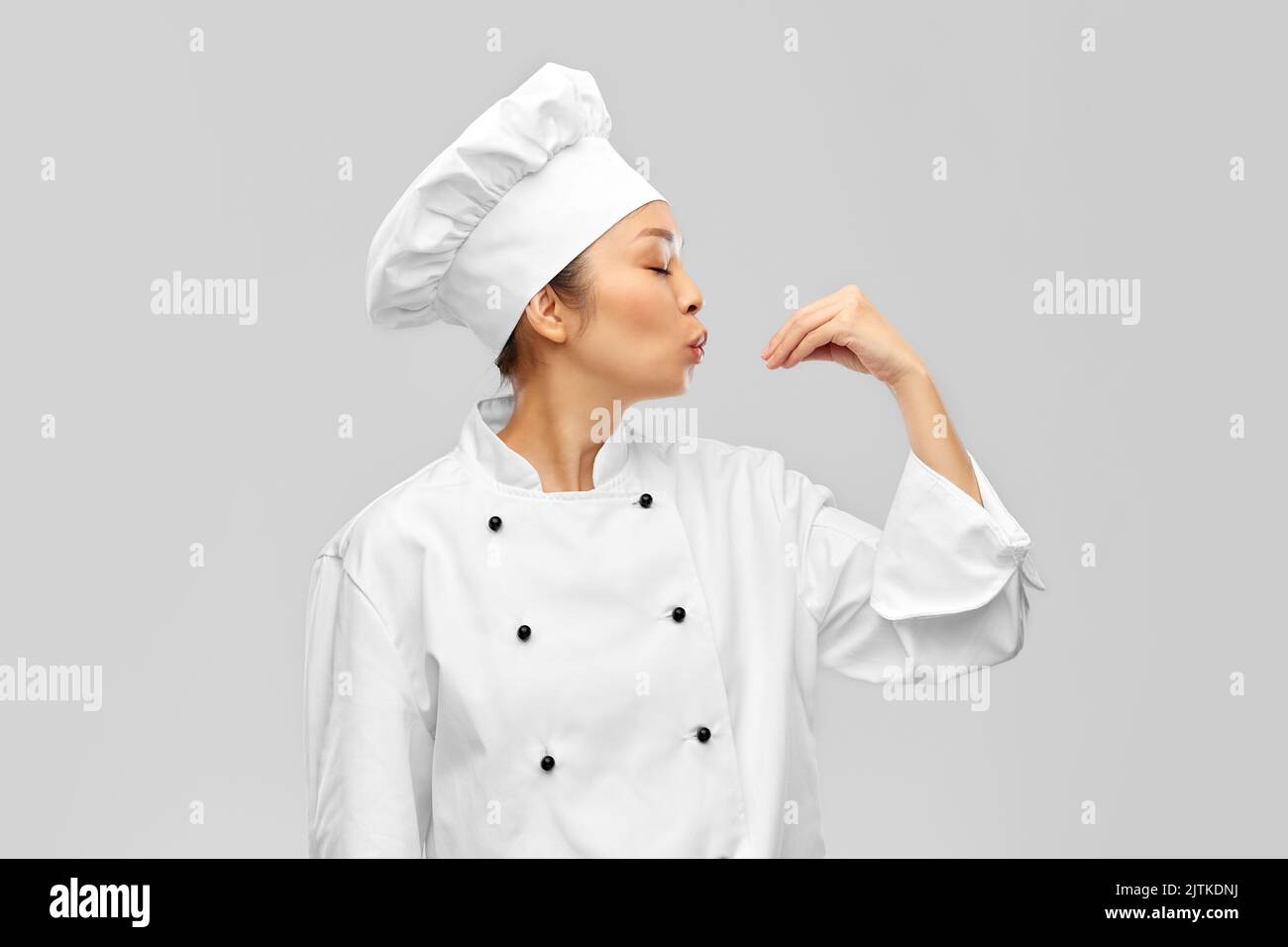 happy female chef showing gourmet sign Stock Photo - Alamy