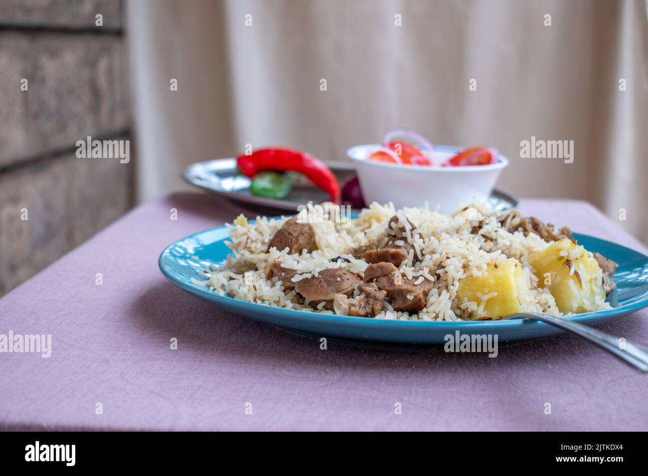 A plate of Kenyan pilau at table level Stock Photo - Alamy