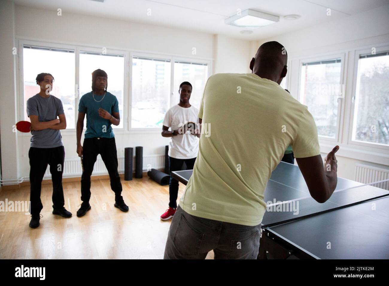 Rear view of coach conducting training sessions with students in games ...