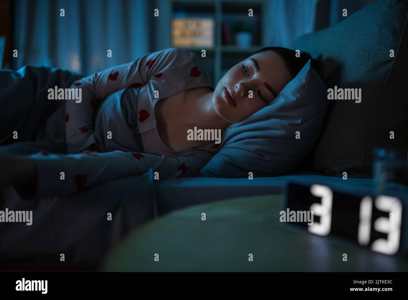 awake teenage girl lying at home at night Stock Photo - Alamy