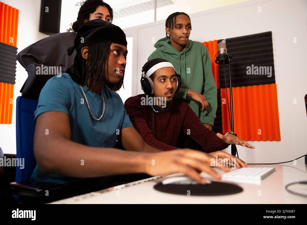 Sound engineers and rappers working together in recording studio Stock ...