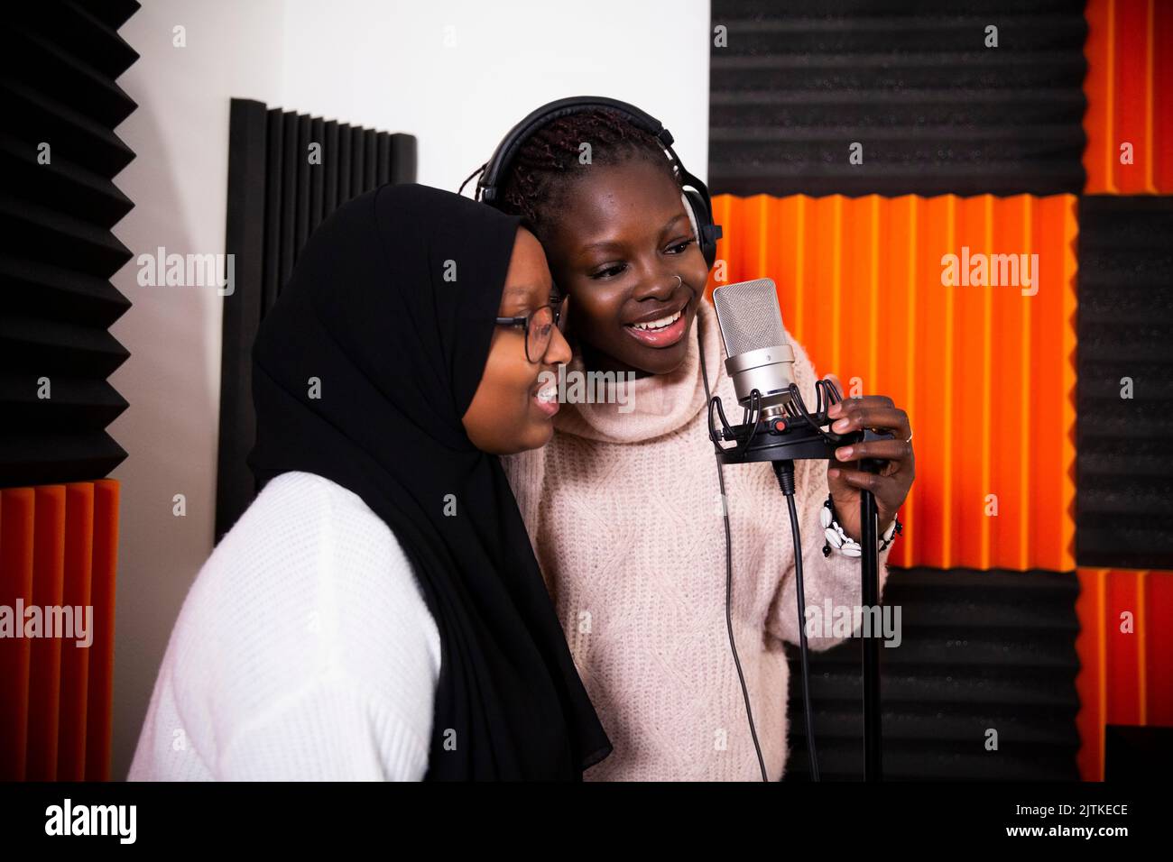 Female singers recording song in studio Stock Photo - Alamy