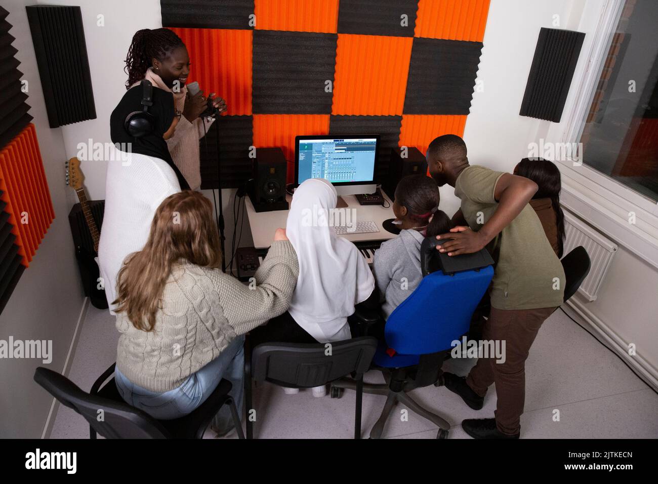 Singer with composers and musicians in recording studio Stock Photo - Alamy