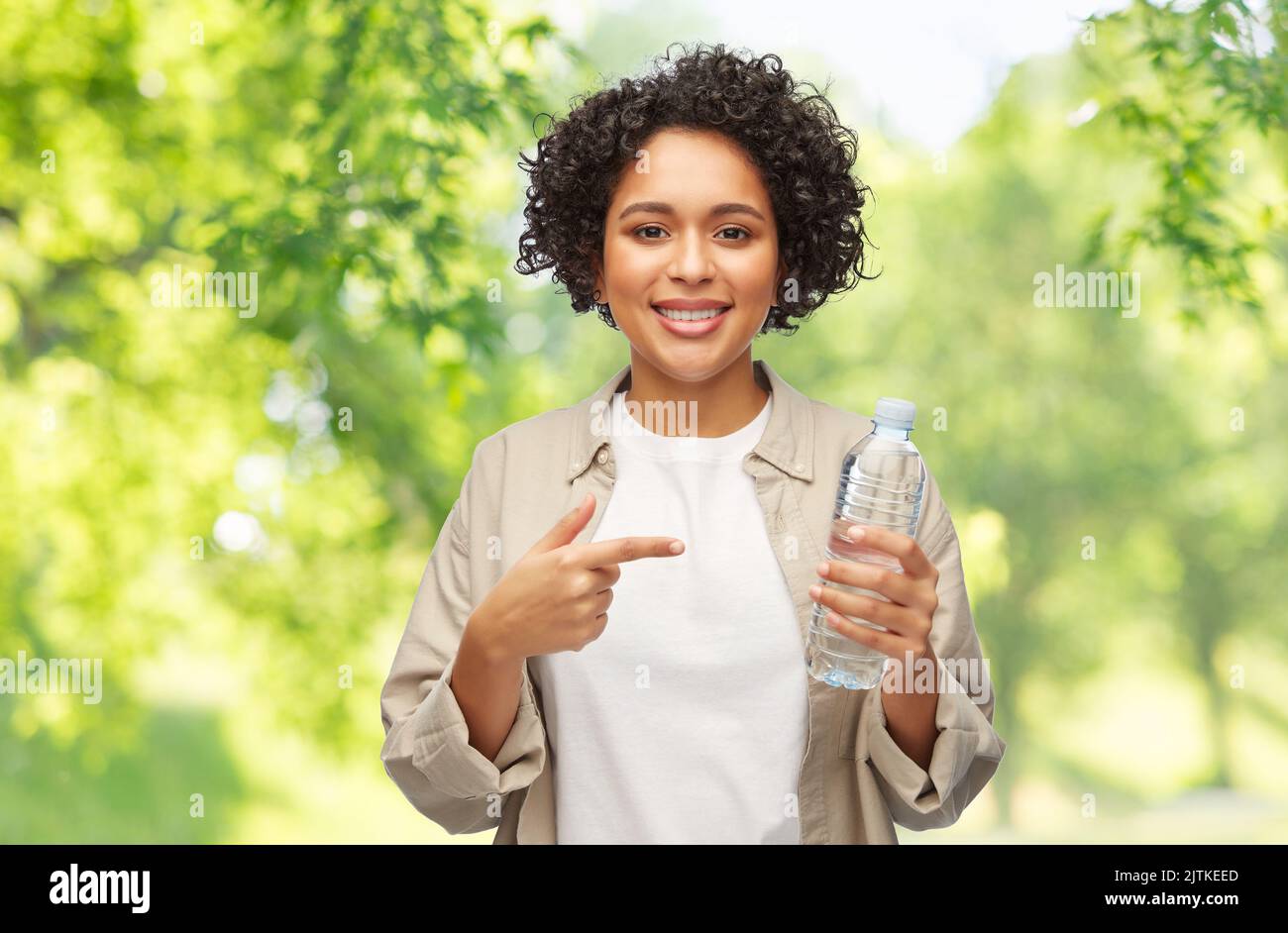 happy woman with water in plastic bottle Stock Photo - Alamy