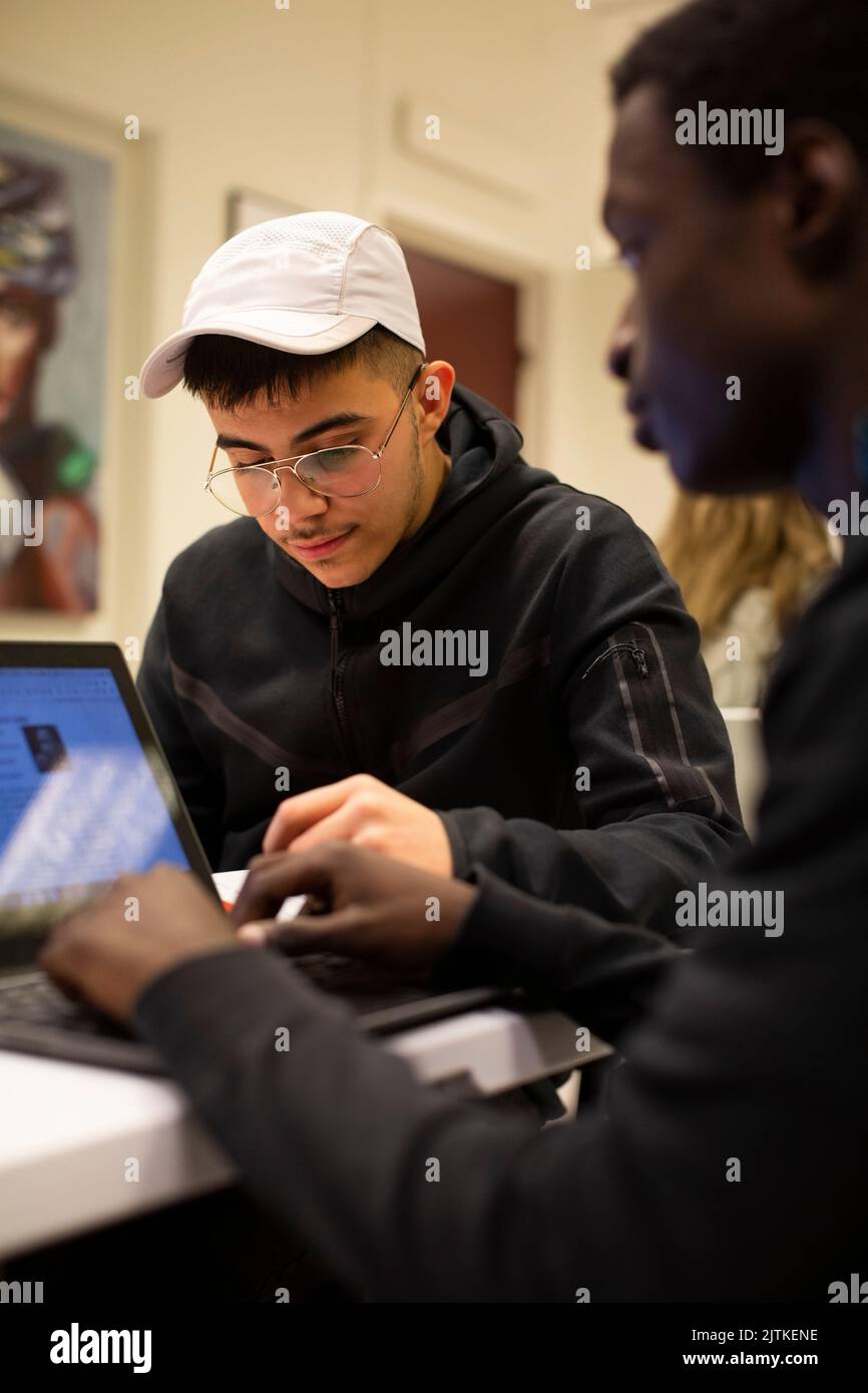 Students studying while sitting in classroom Stock Photo - Alamy