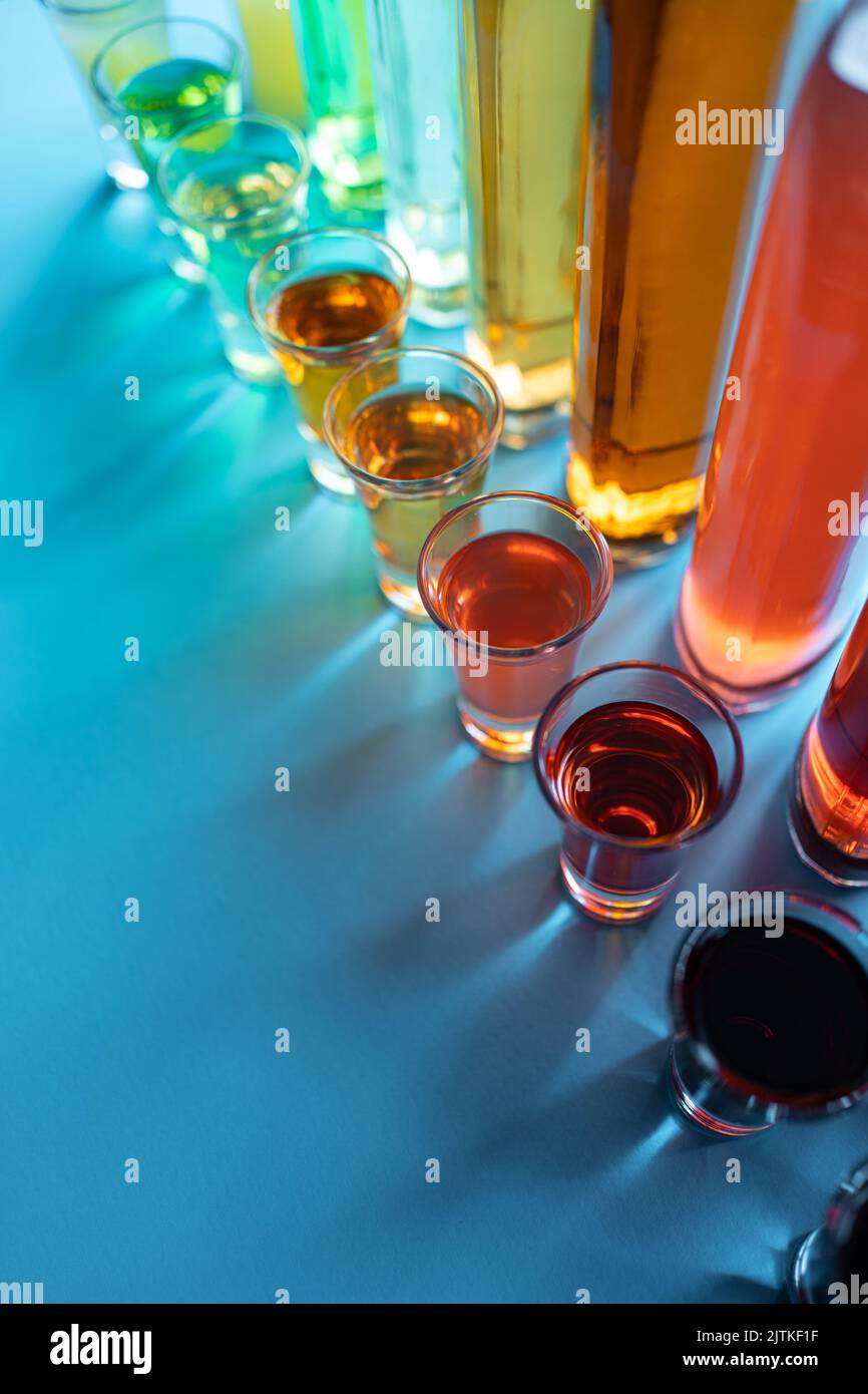 collection set of colored alcohol tincture or liquor with shot glass ...