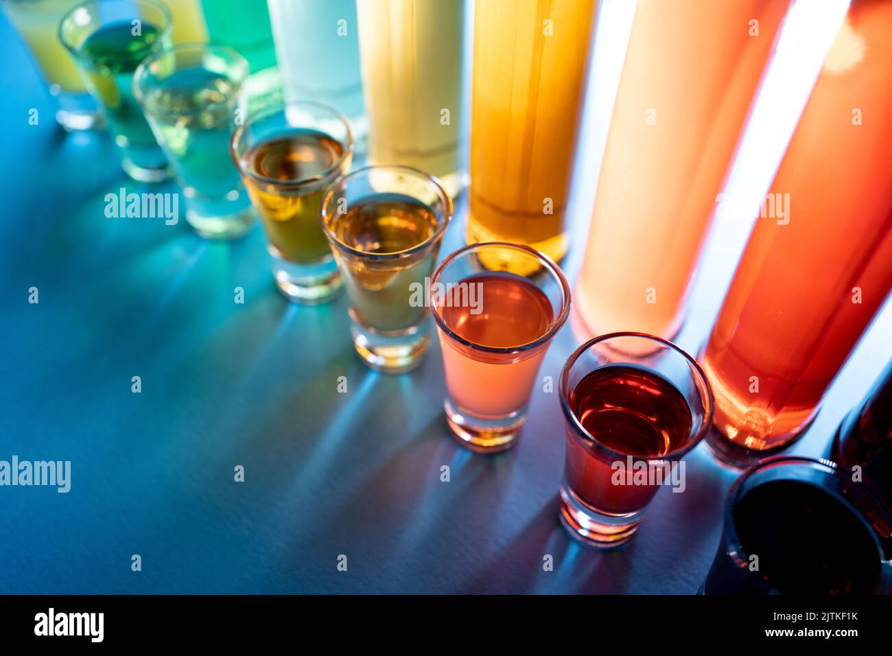 collection set of colored alcohol tincture or liquor with shot glass ...