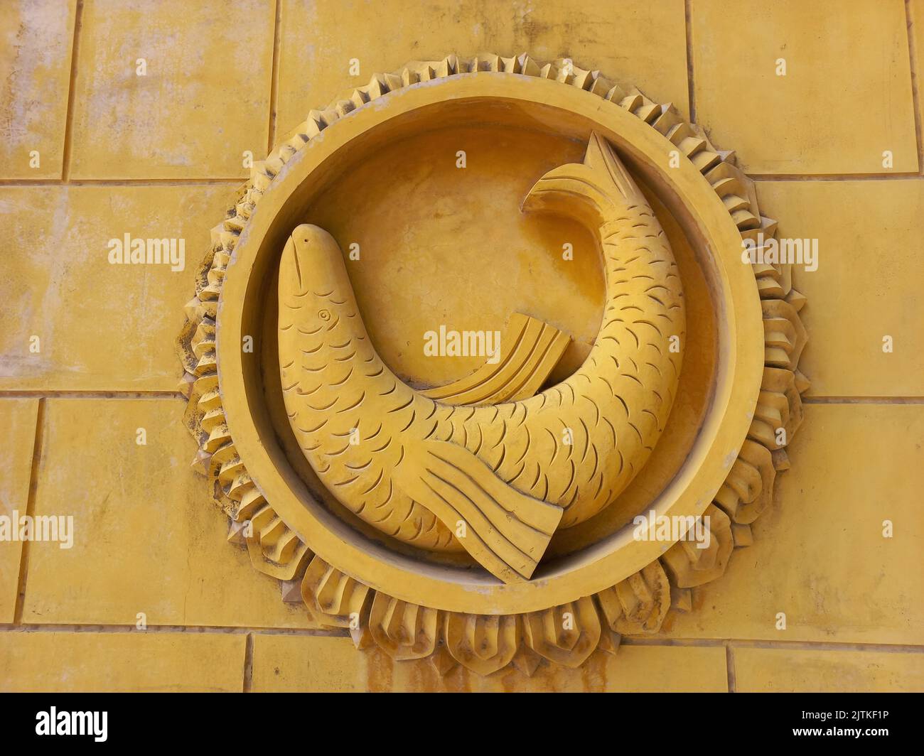 A closeup shot of a craved stone fish Idol of Hindu deities in Vadodara ...