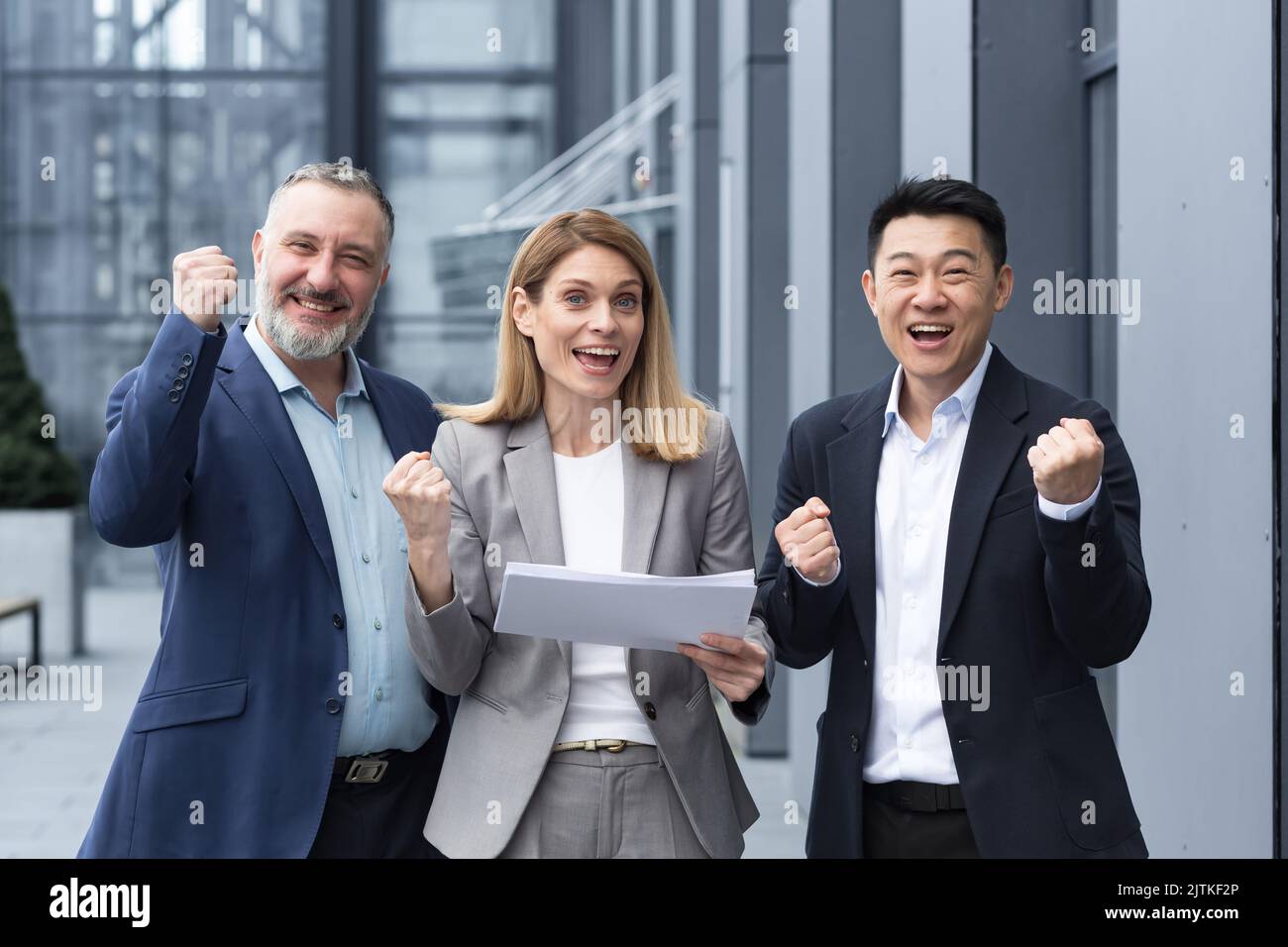 Businesswoman boss with her diverse team looking at the camera and ...