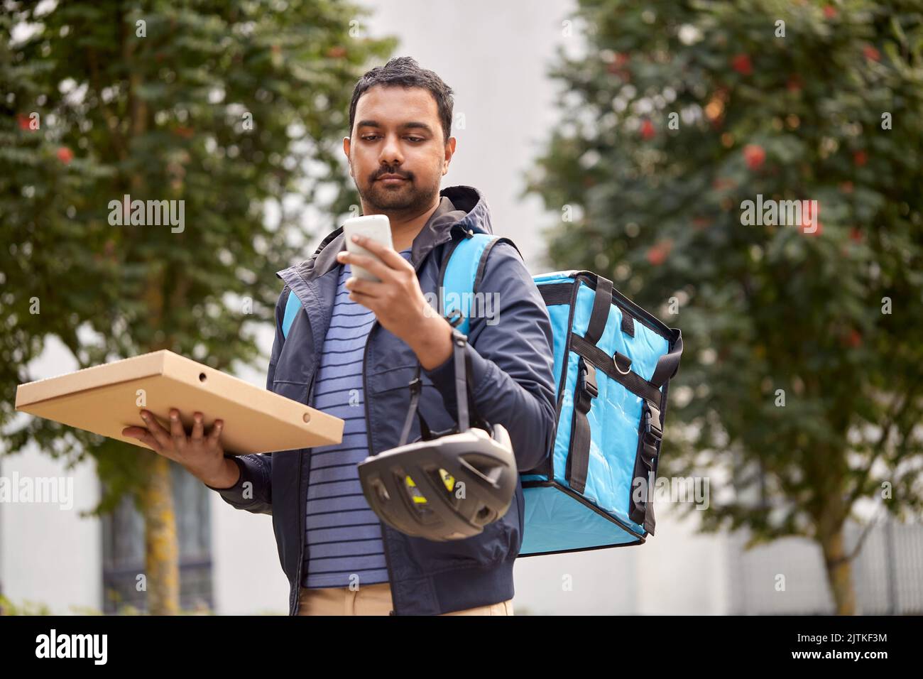 food delivery man with takeaway pizza and phone Stock Photo - Alamy