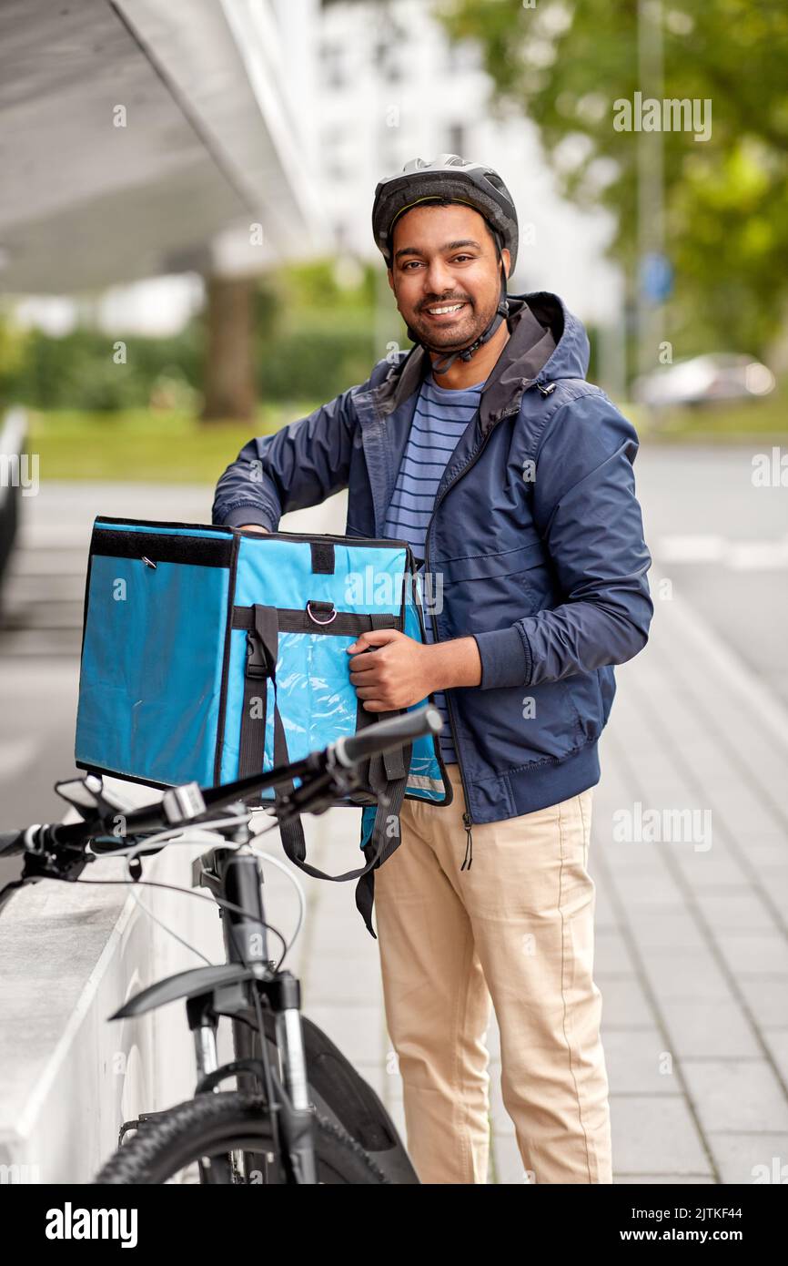 indian delivery man with bag and bicycle in city Stock Photo - Alamy