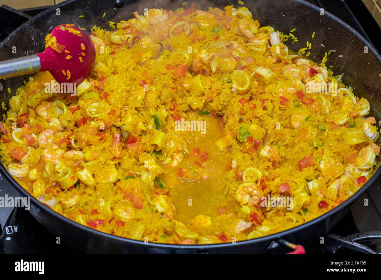Cooking a paella spanish traditional food Valencia Stock Photo - Alamy