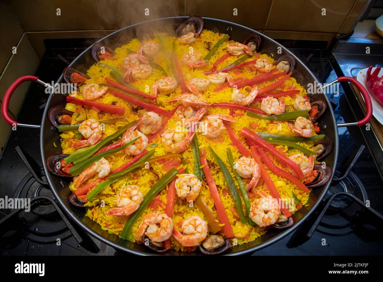 Cooking a paella spanish traditional food Valencia Stock Photo - Alamy