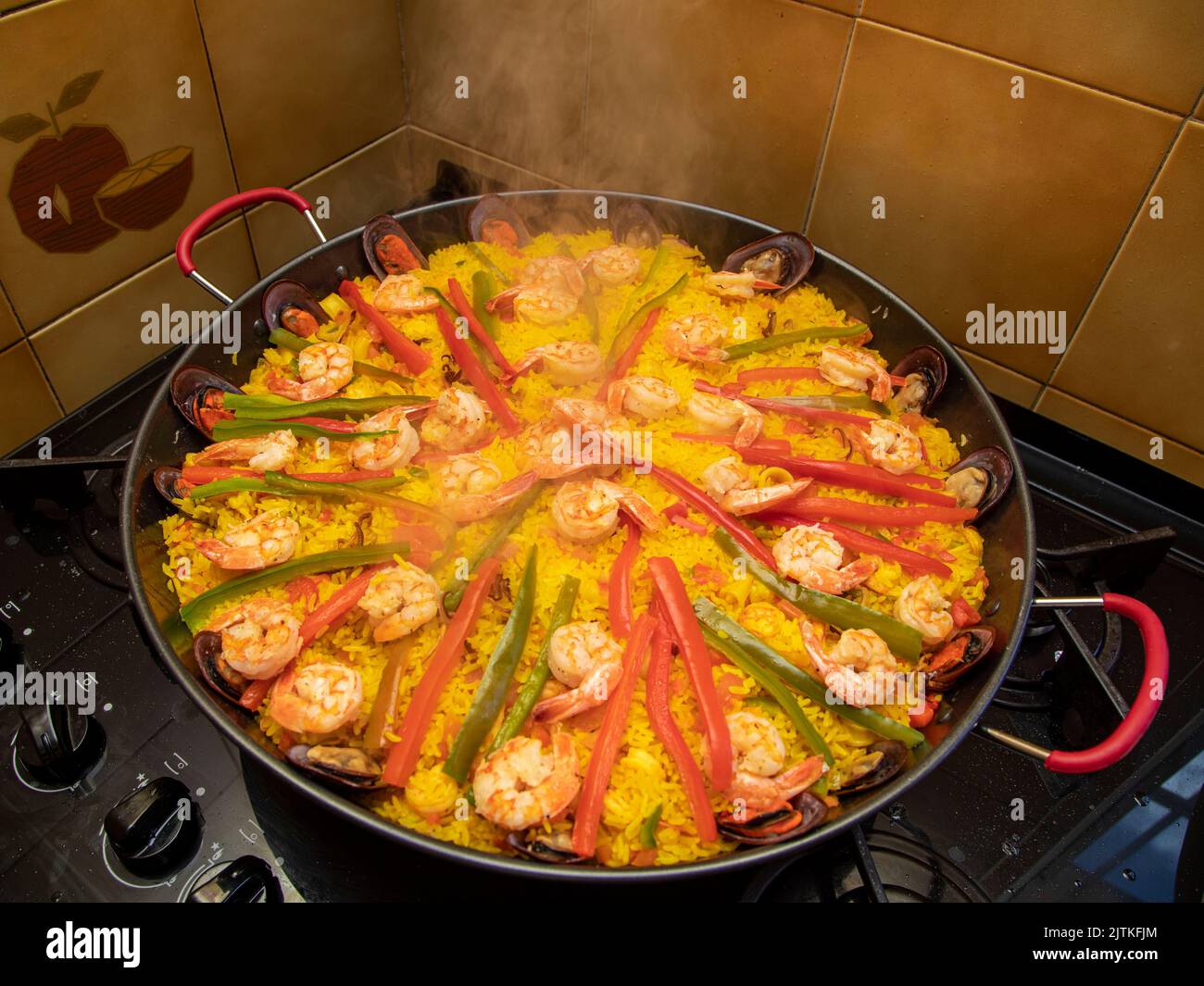 Cooking a paella spanish traditional food Valencia Stock Photo - Alamy