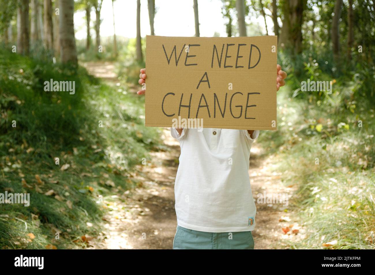 anonymous child displays sign with the message "we need a change Stock ...