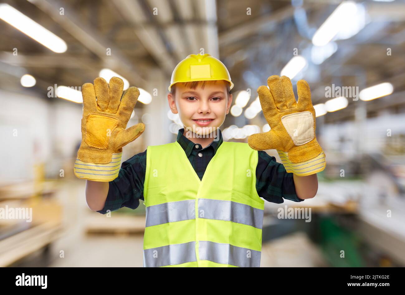 little boy in protective helmet and safety vest Stock Photo - Alamy