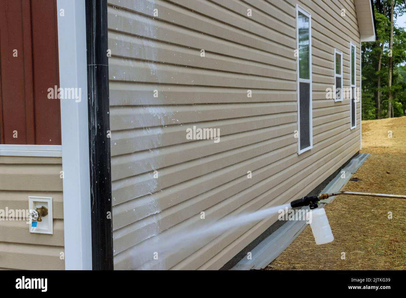 A cleaning service with a powerful nozzle that sprays water on a high ...