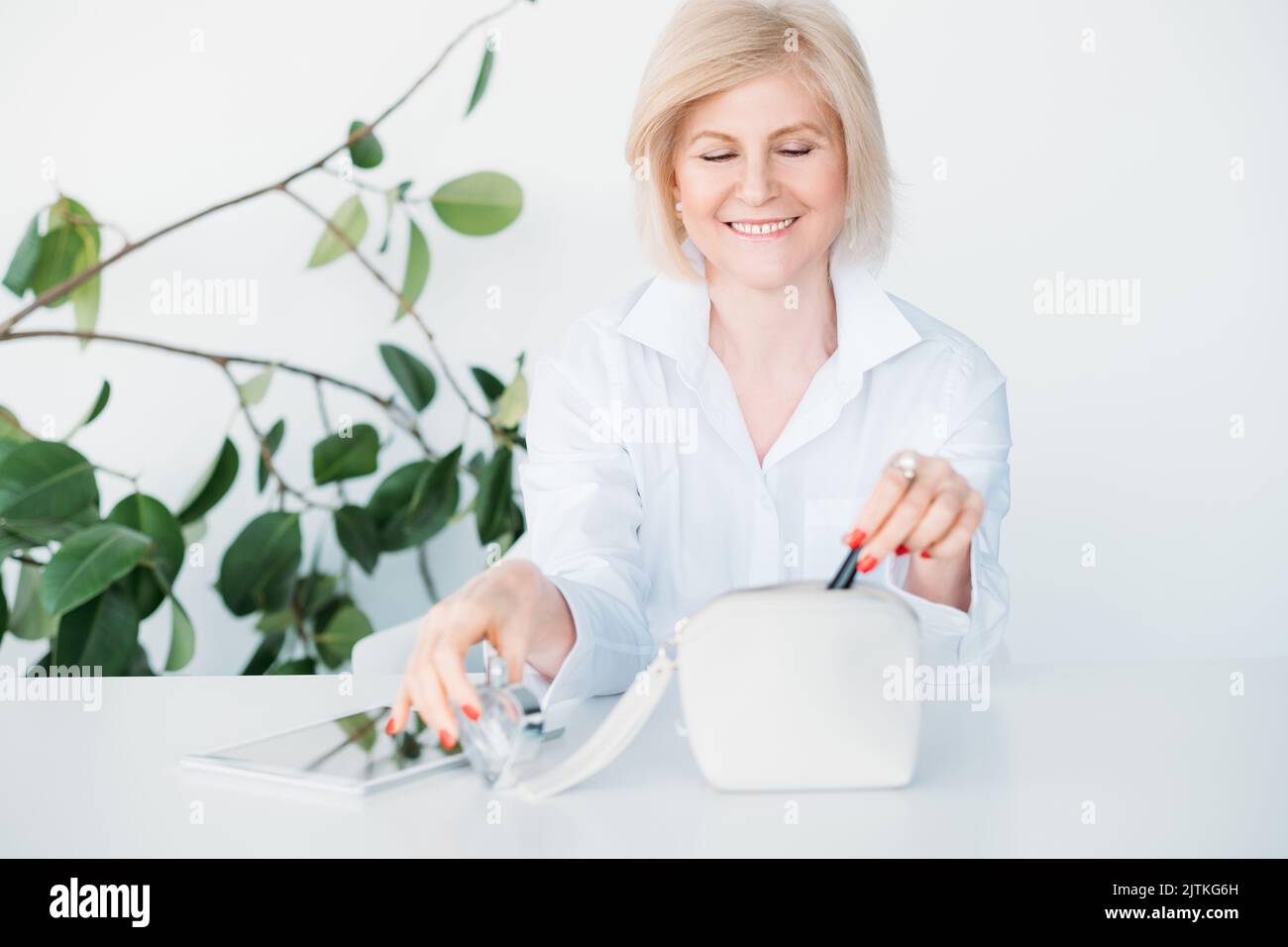 smiling aged lady beauty products choice advice Stock Photo - Alamy