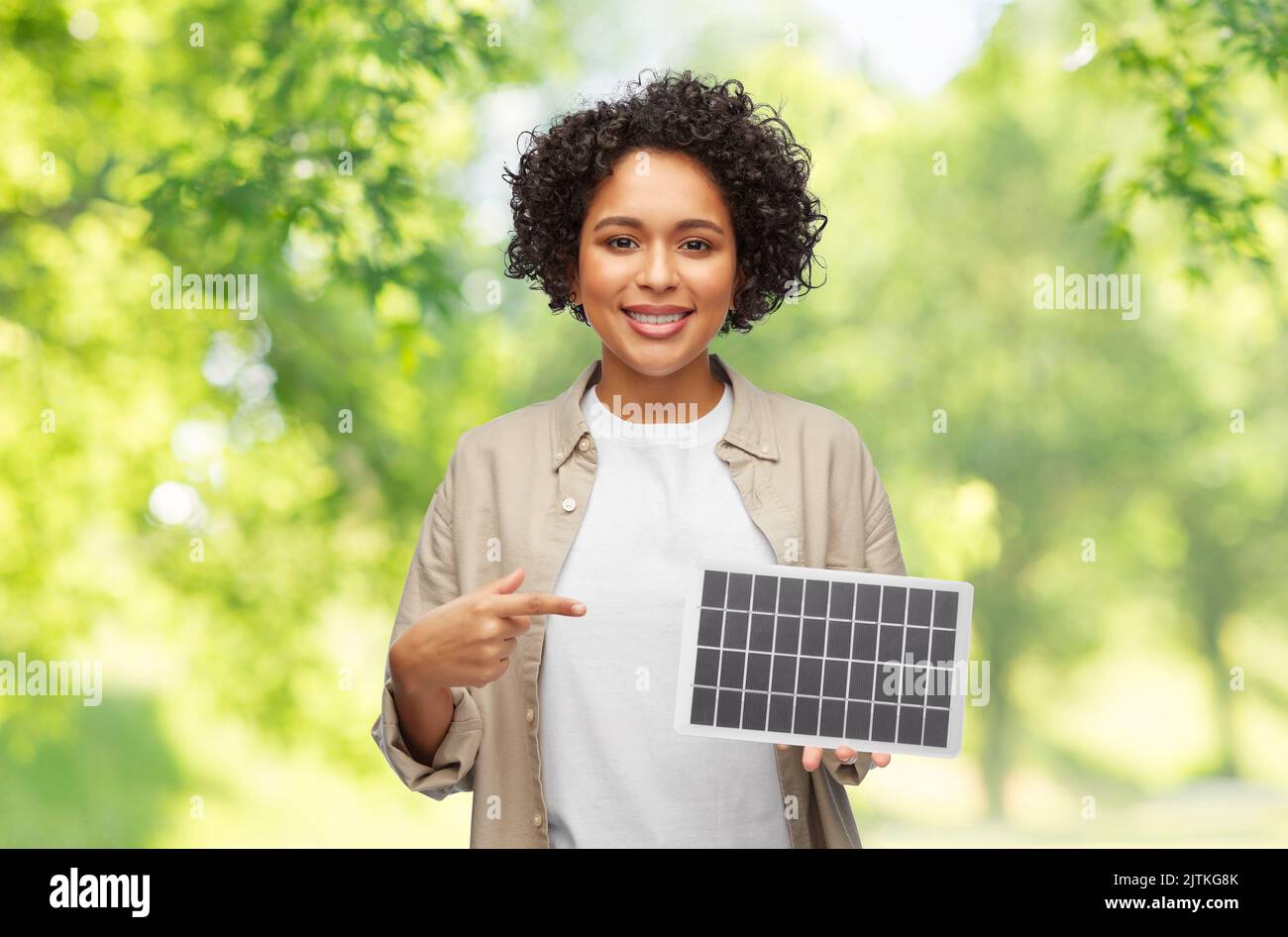 happy smiling woman showing solar battery model Stock Photo - Alamy
