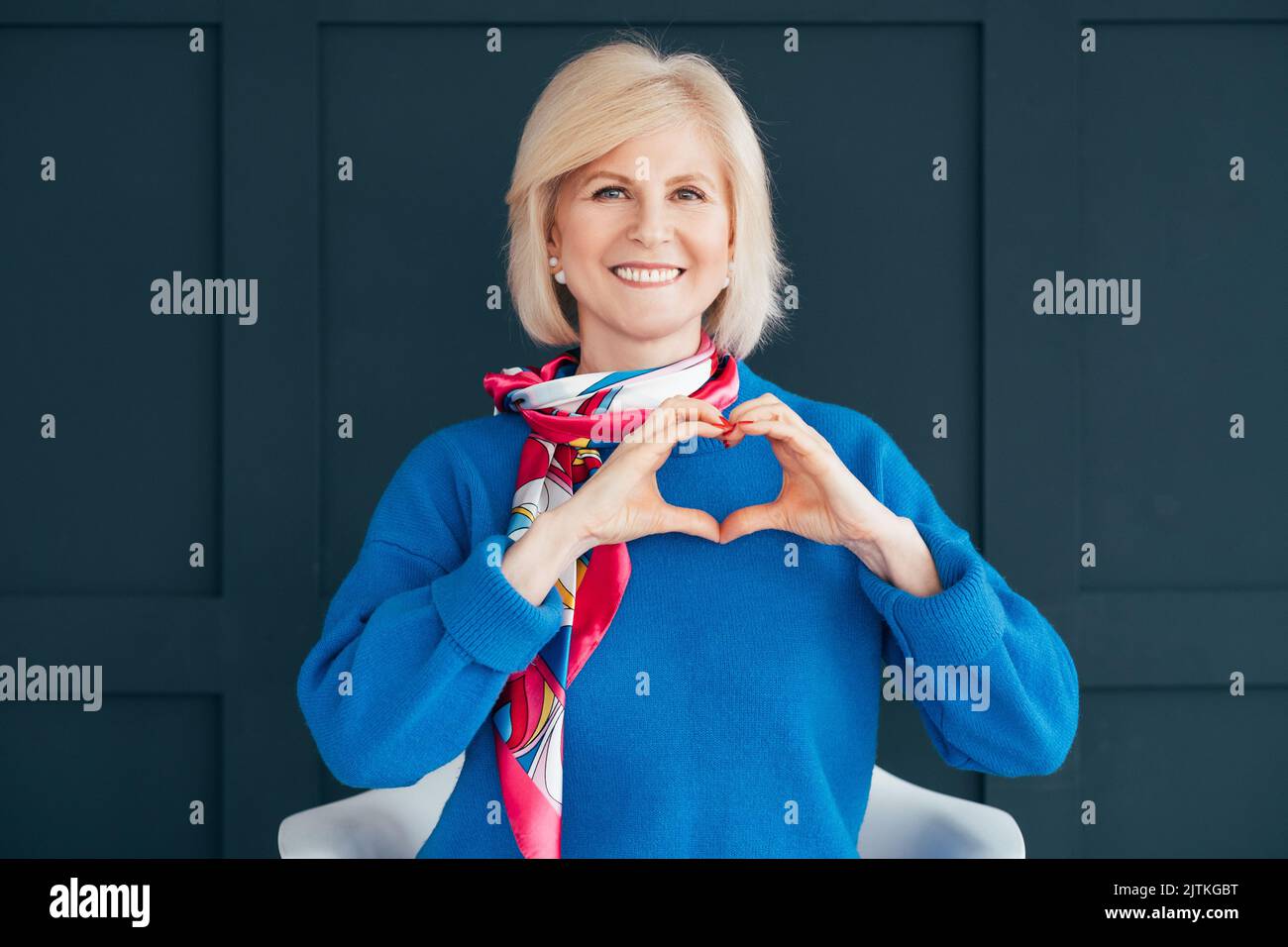 smiling senior lady heart sign care harmony Stock Photo - Alamy
