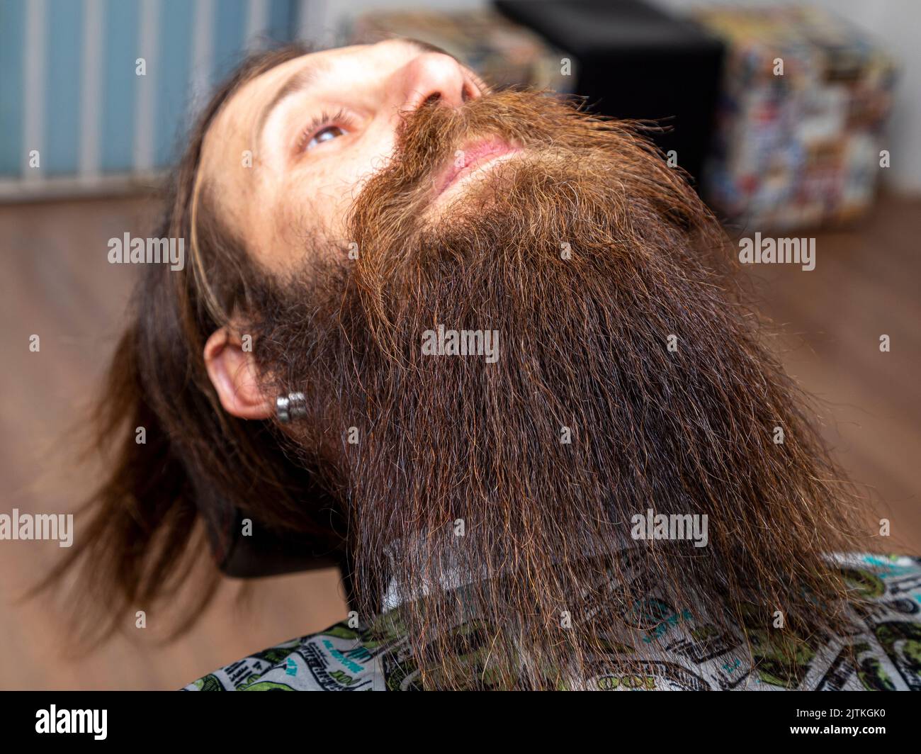 Hairy and bearded man in barbershop Stock Photo - Alamy