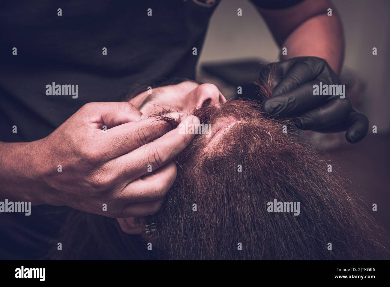 Barber cutting a man's mustache Stock Photo - Alamy