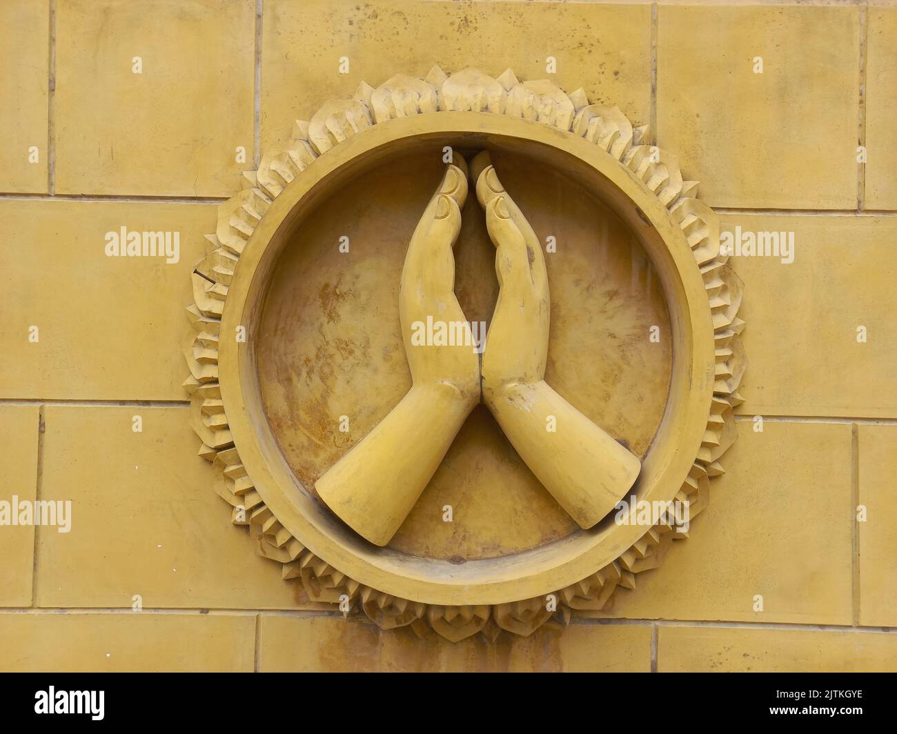 A Hindu Design Sculpture of praying hands inside a Circle in the stone ...