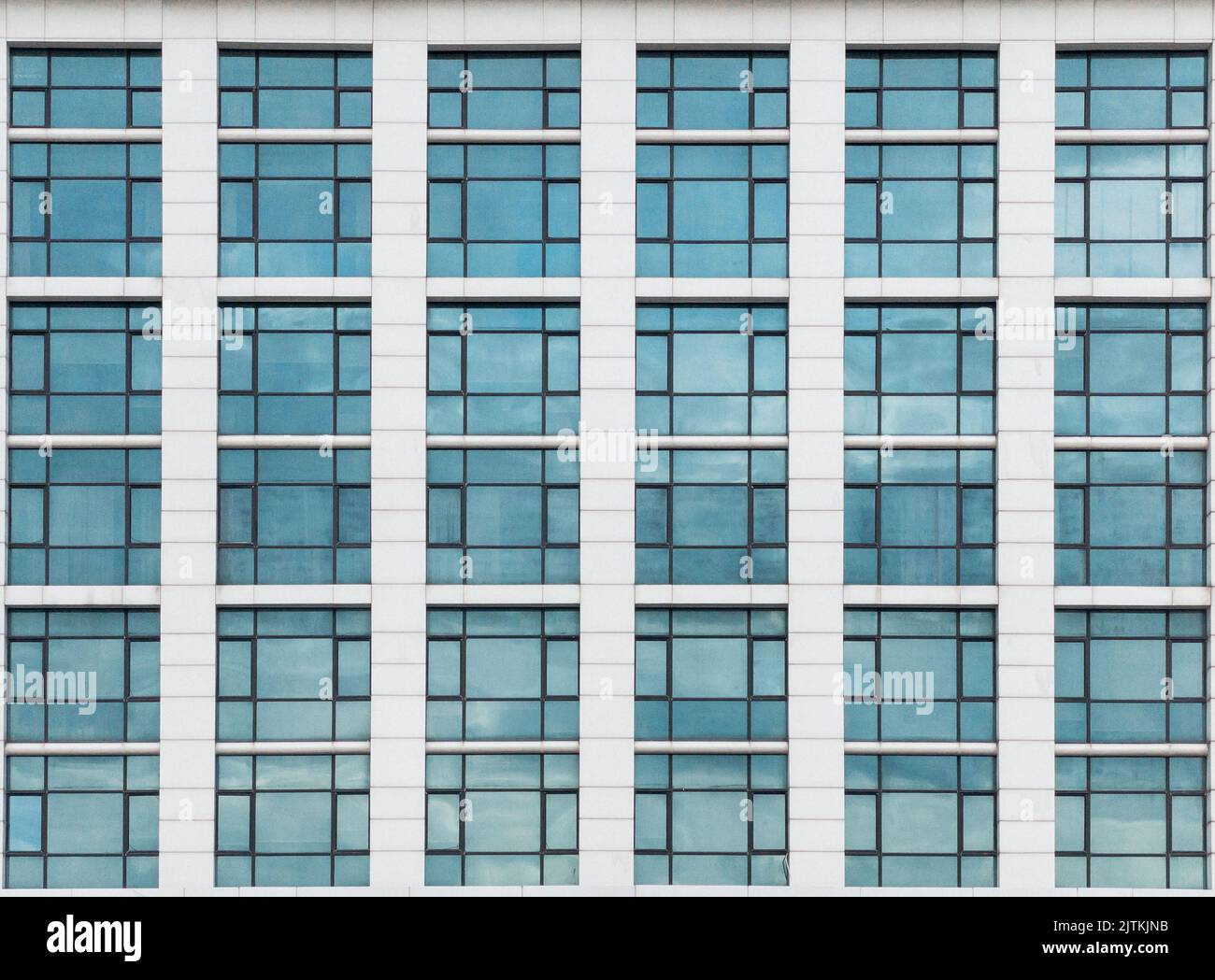 The glass window pattern on the building wall with the cloud reflection ...