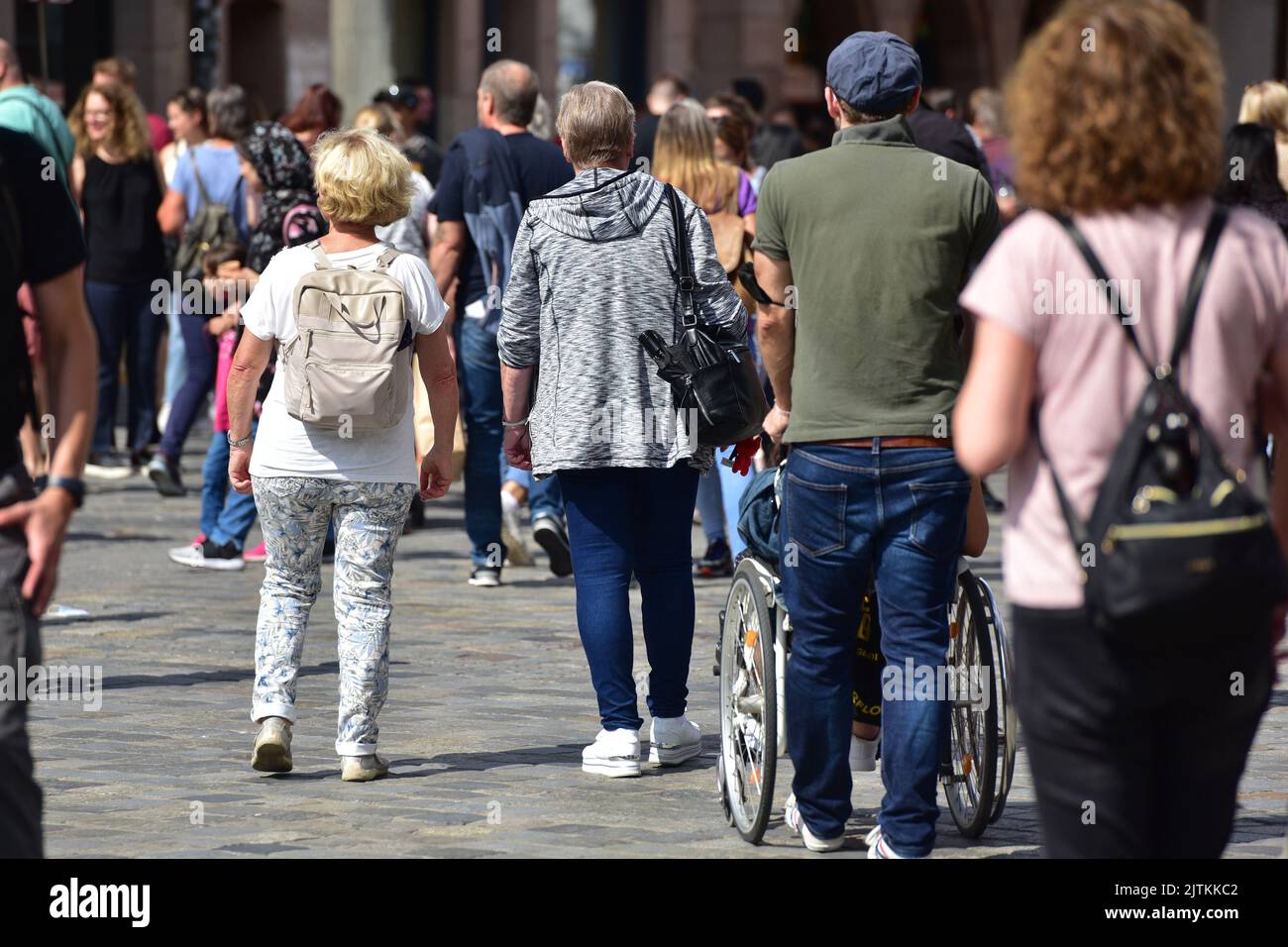 Street scene with many people walking from behind Stock Photo - Alamy