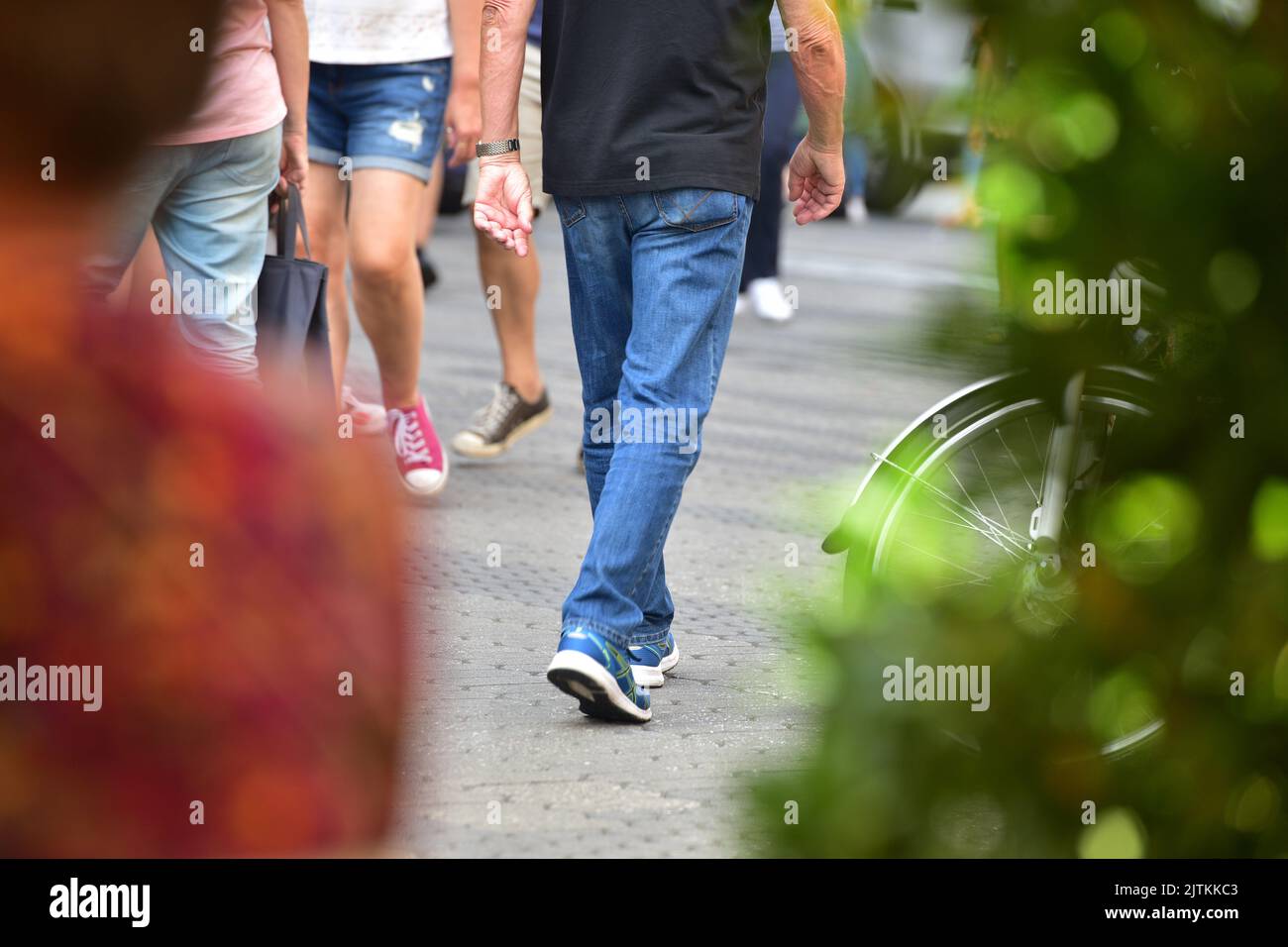 Street scene with many people walking from behind Stock Photo - Alamy