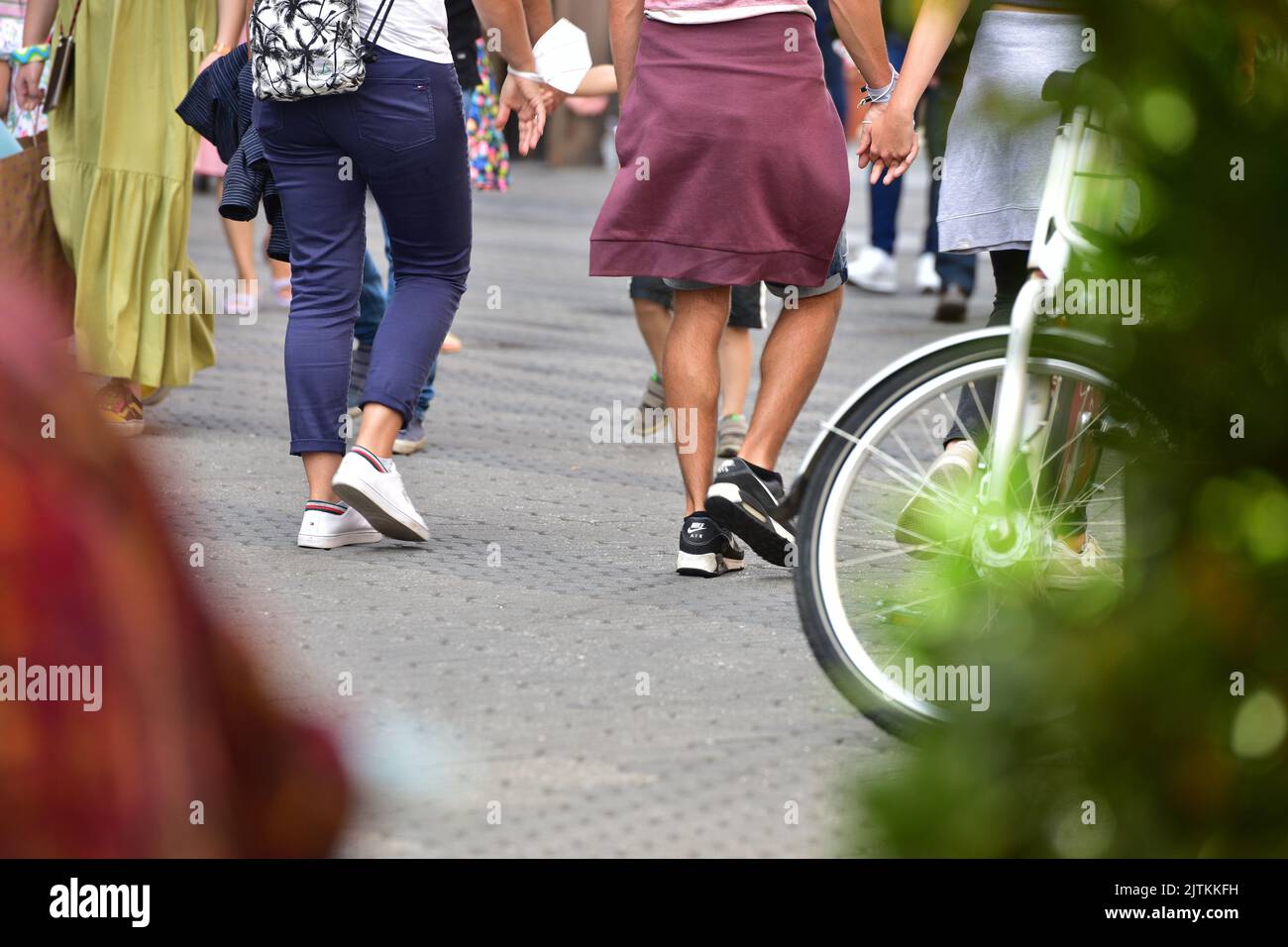 Street scene with many people walking from behind Stock Photo - Alamy