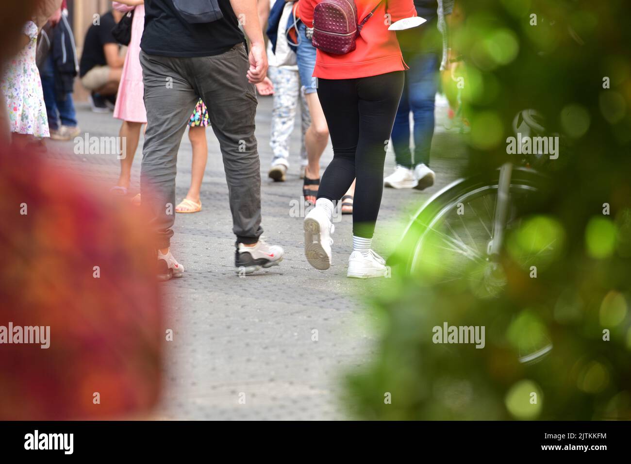 Street scene with many people walking from behind Stock Photo - Alamy
