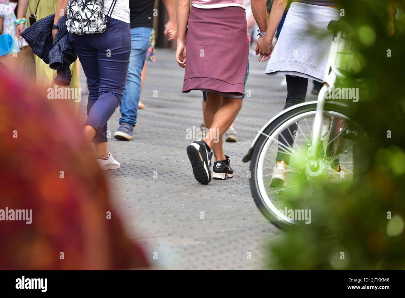 Street scene with many people walking from behind Stock Photo - Alamy