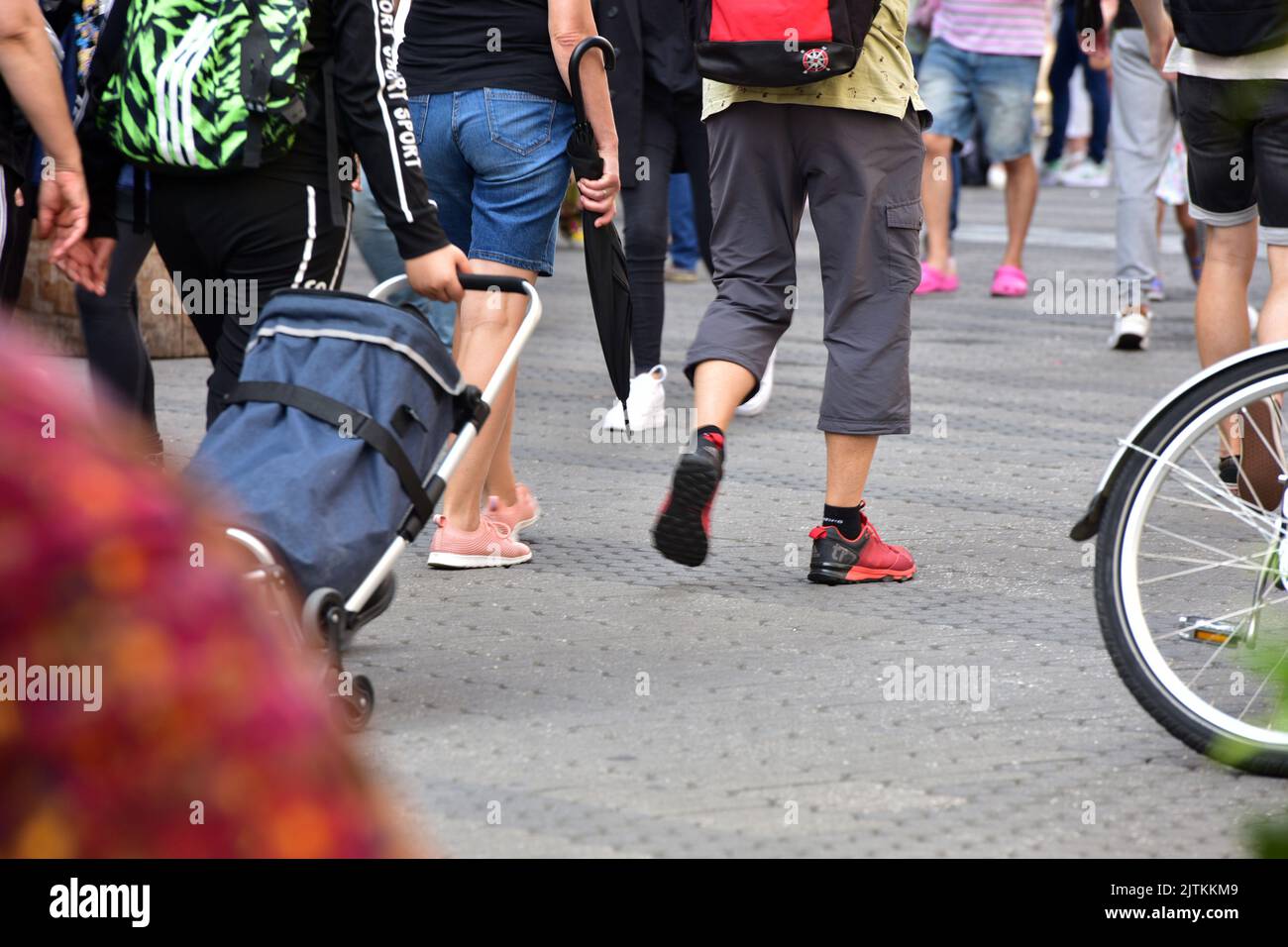 Street scene with many people walking from behind Stock Photo - Alamy