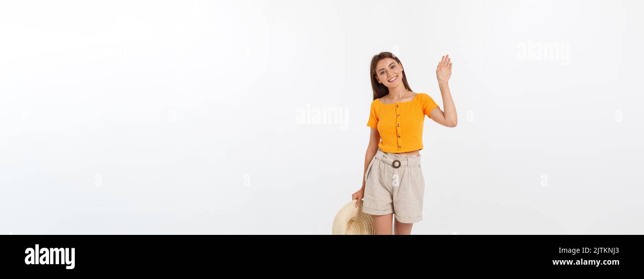 young pretty woman smiling happily and cheerfully, waving hand ...