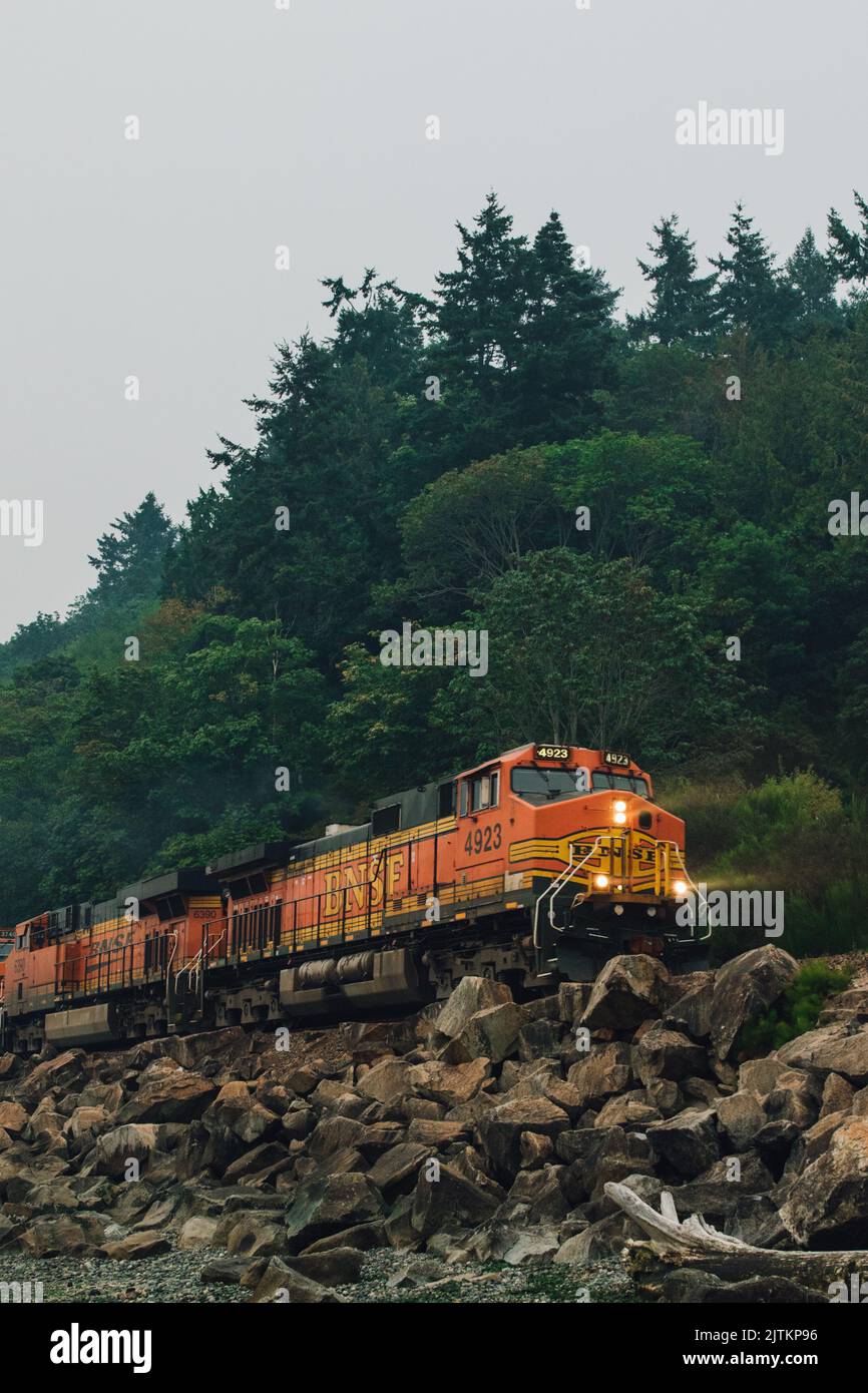 BNSF freight train traveling through Carkeek Park during a smoky ...