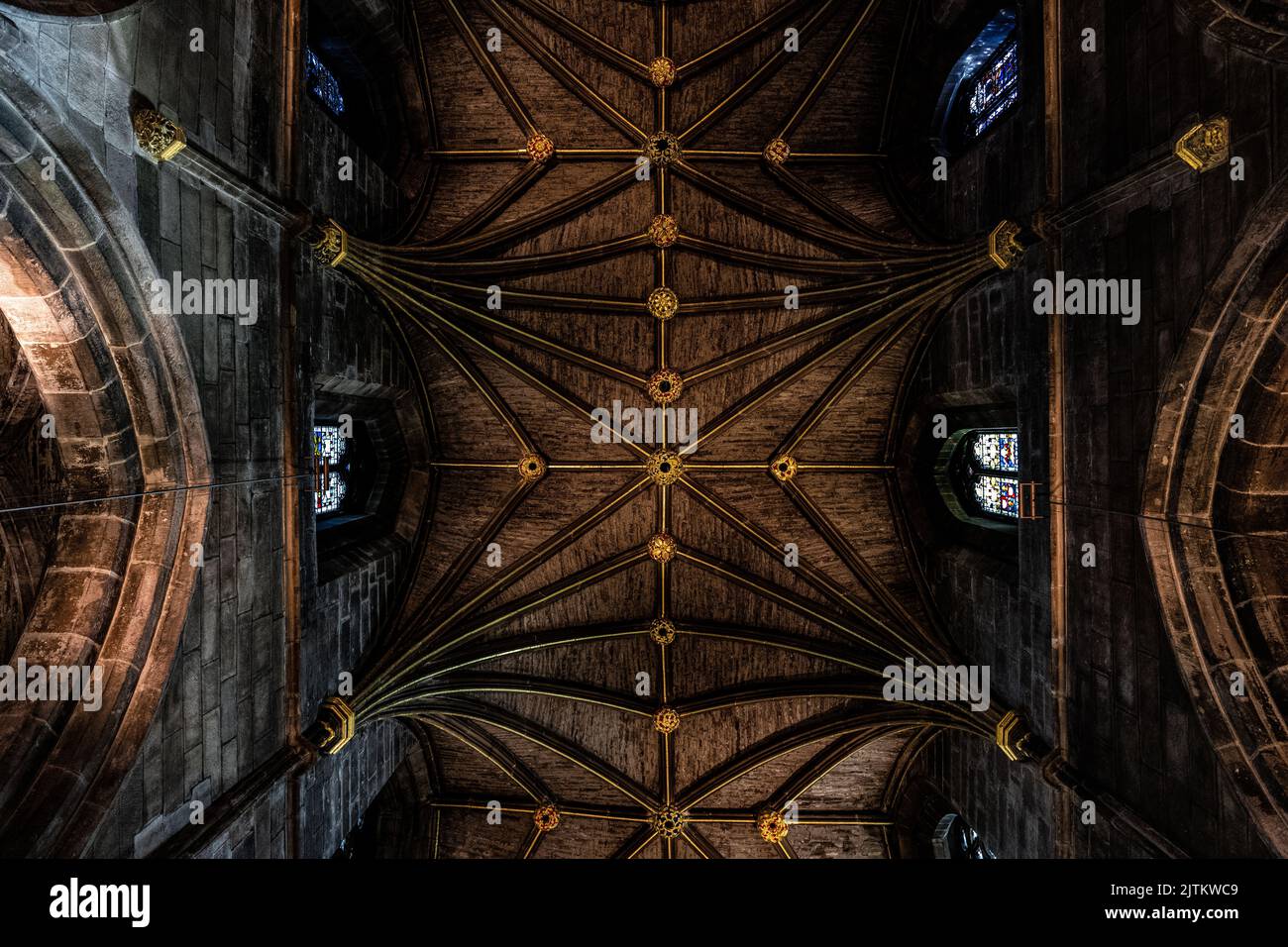 Stone ceiling of the cathedral with arches and stained glass windows ...