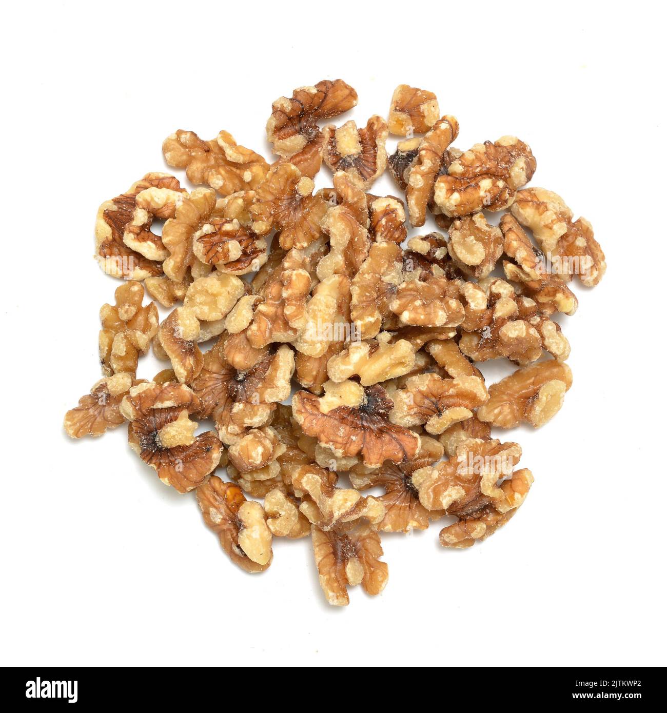 Pile of broken walnut pieces on white shot from above cut out on white ...