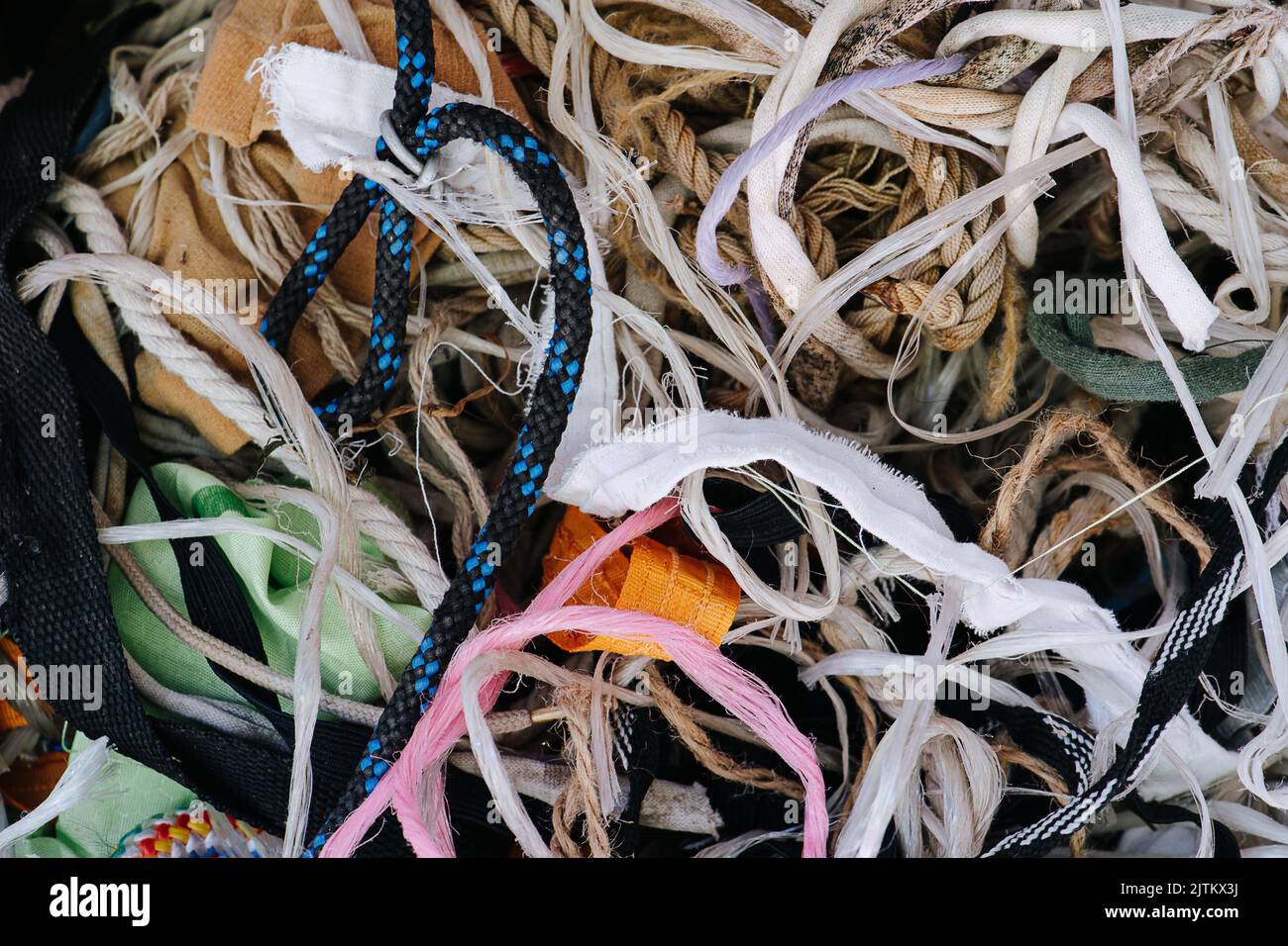 Top view of an old decaying yellowing ropes in a bundle. Close up ...